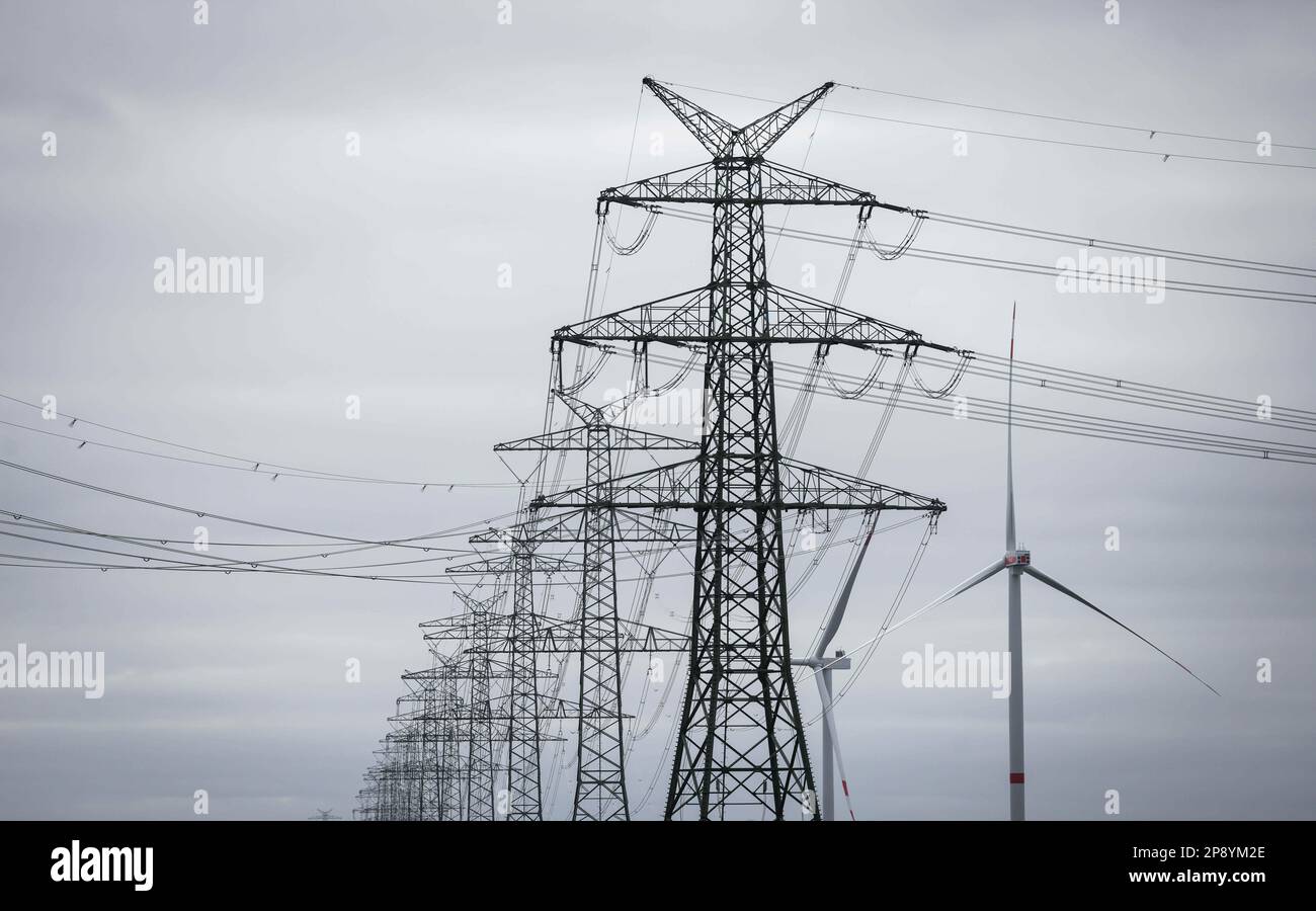 Heide, Germany. 03rd Mar, 2023. Power pylons and a wind turbine are ...