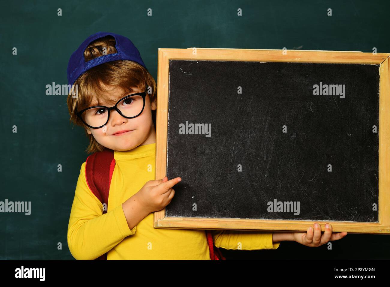 Happy smiling pupils drawing at the desk. Cheerful smiling child at the ...