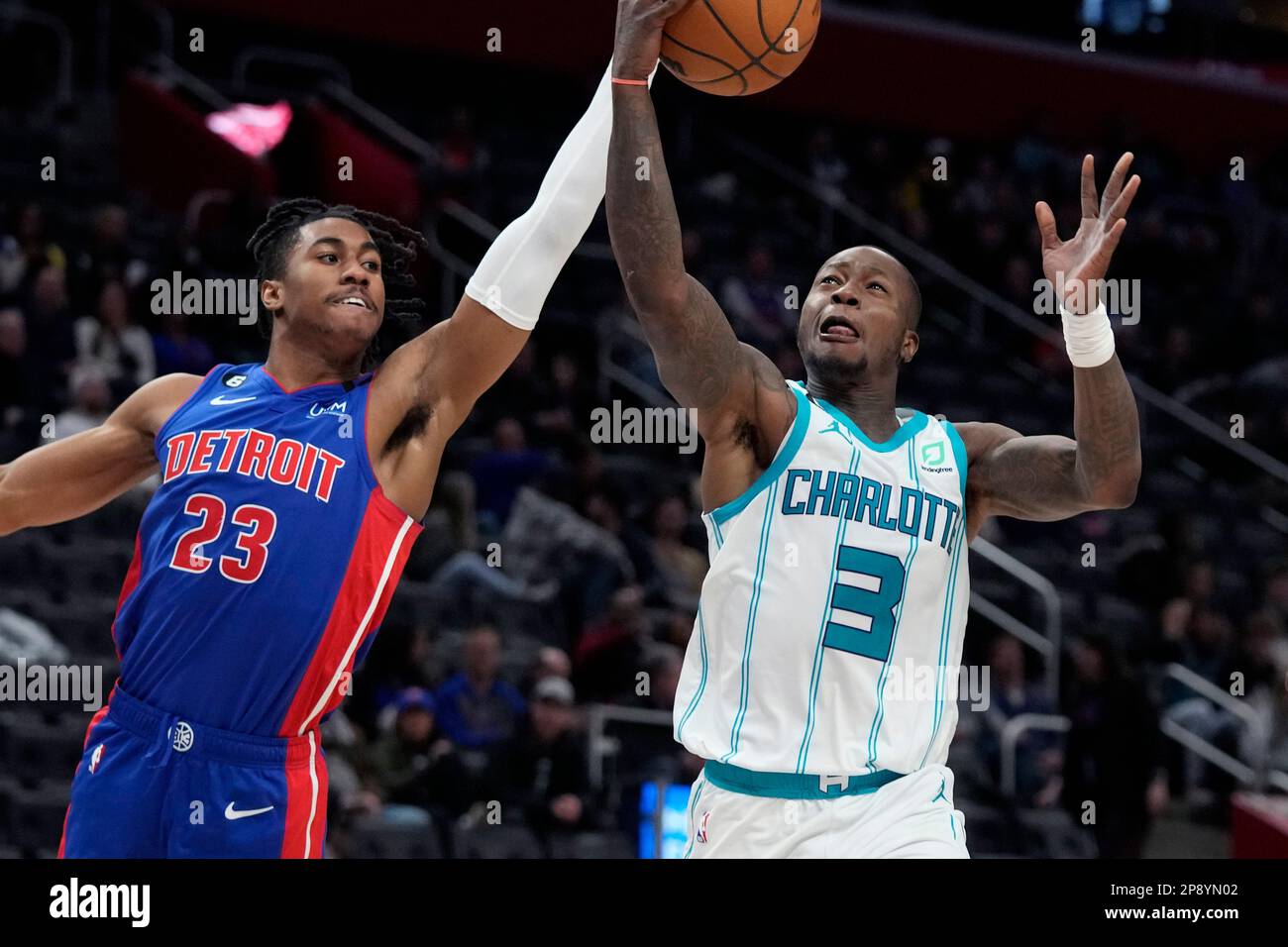 Detroit Pistons guard Jaden Ivey (23) fouls Charlotte Hornets guard Terry Rozier (3) during the ...