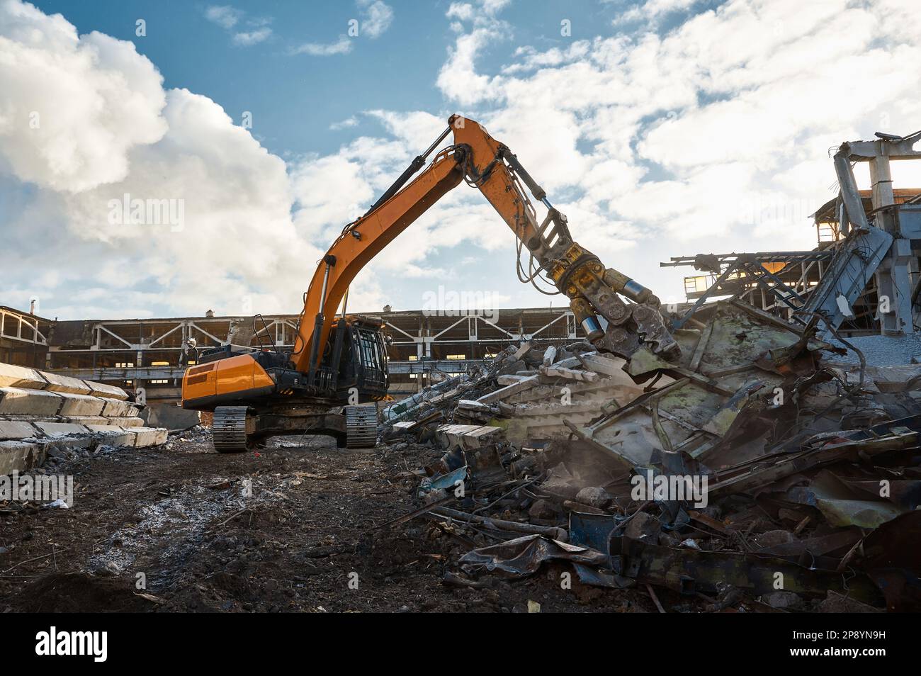 Excavator destroyer removes debris winter day Stock Photo - Alamy