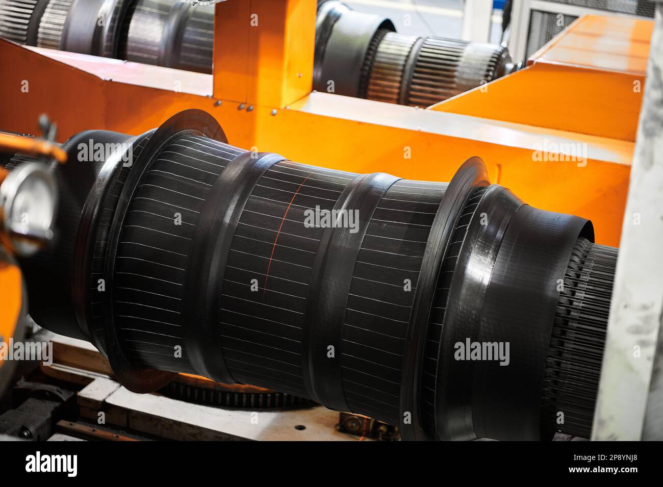 Rubber workpiece on shaft forming tire in factory workshop Stock Photo ...