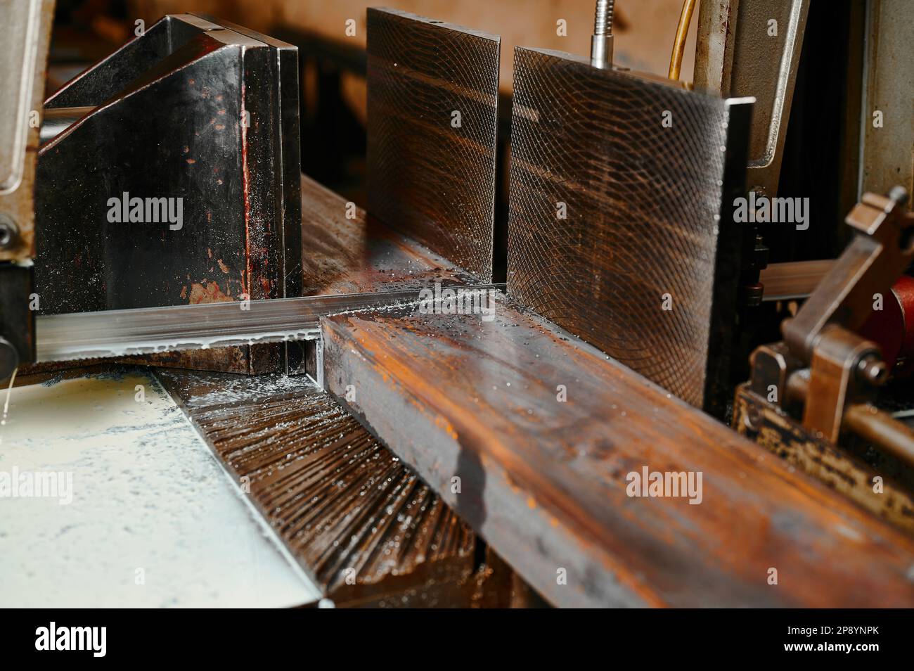 Cutting metal beam with band saw in plant workshop Stock Photo - Alamy