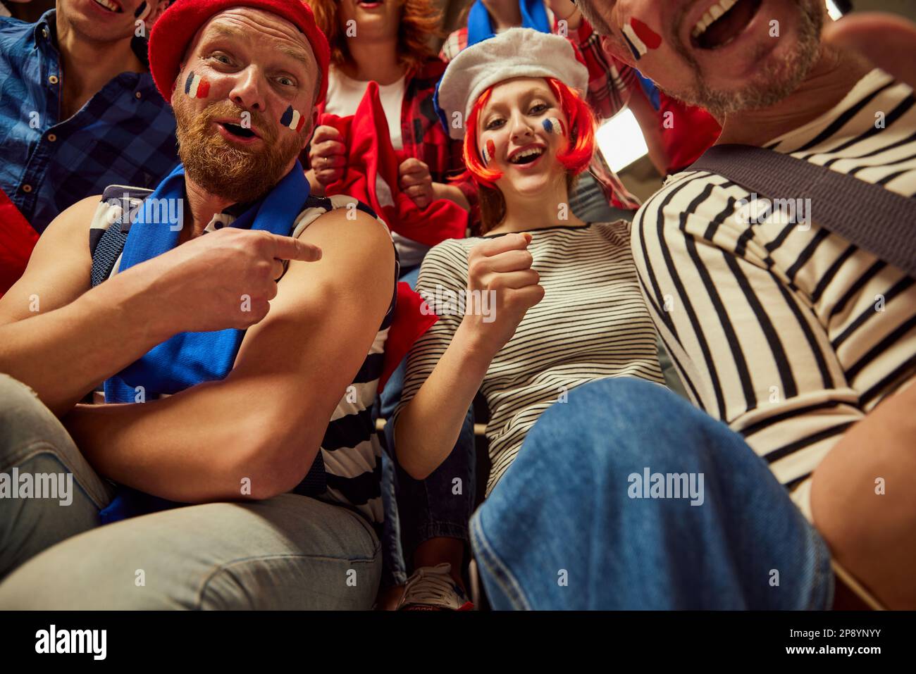 Bottom view. Football, soccer fans emotionally cheering up favourite ...