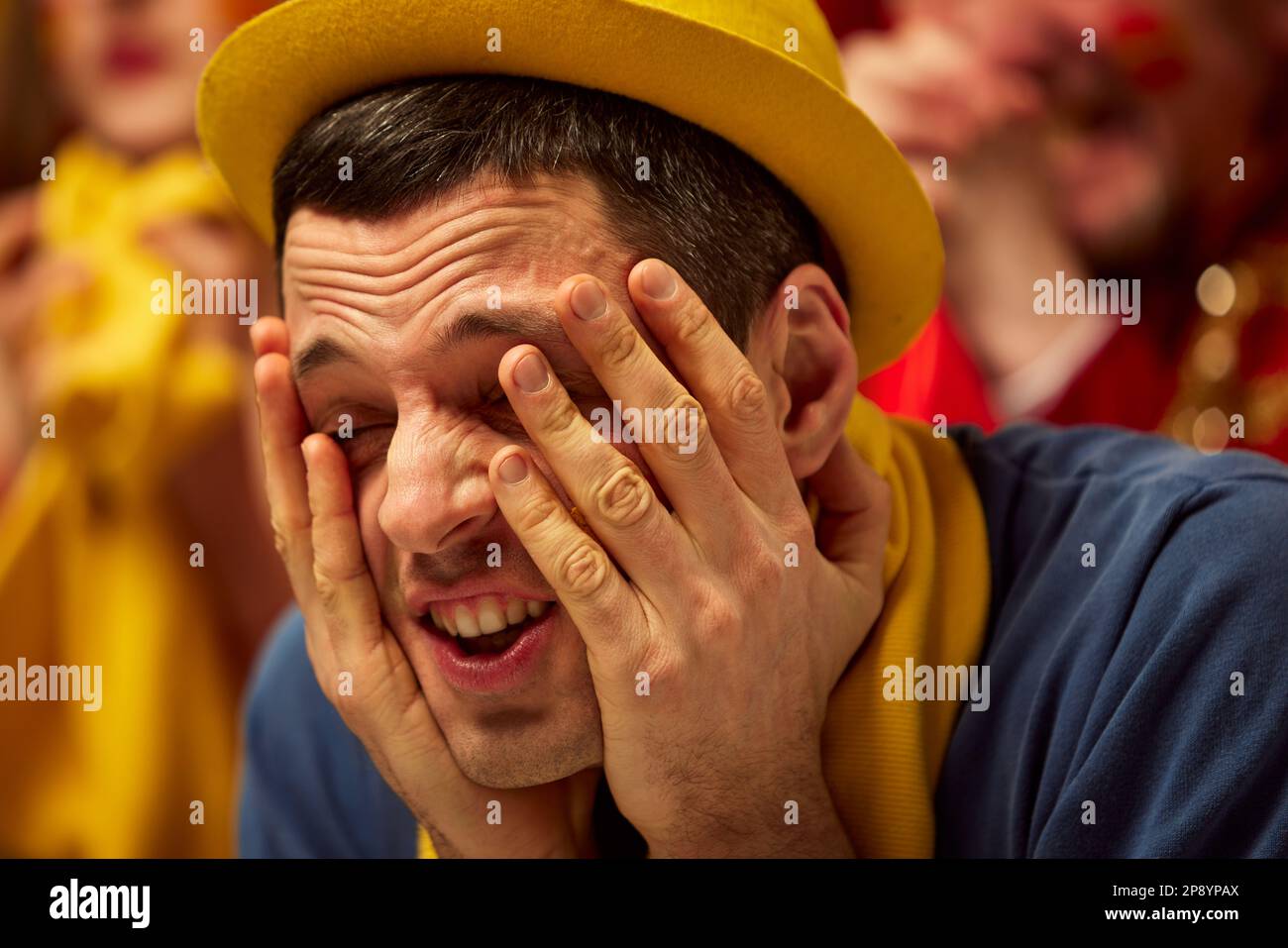 Close-up image of young man, football, soccer fans emotionally watching ...