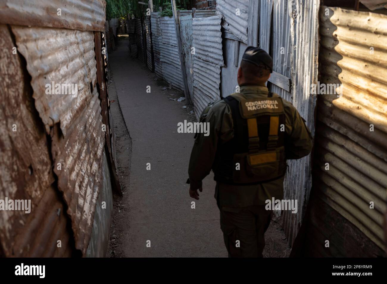 A border police agent patrols inside Los Pumitas neighborhood, where ...