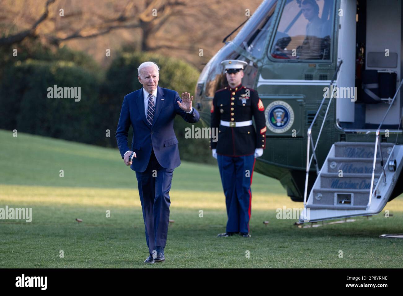 United States President Joe Biden waves as he returns to the White ...
