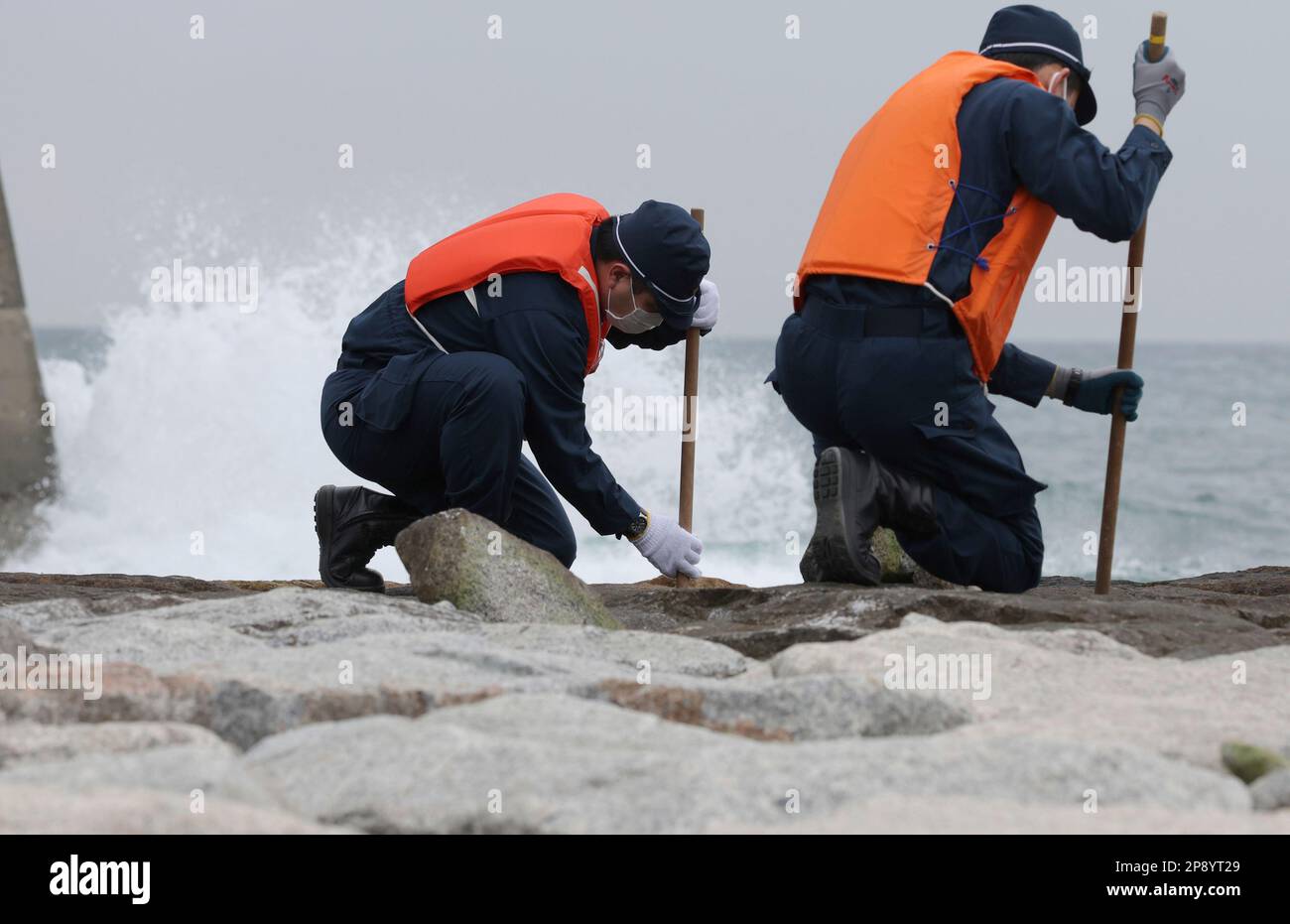 Fukushima Prefectural police officers search for four missing people at ...