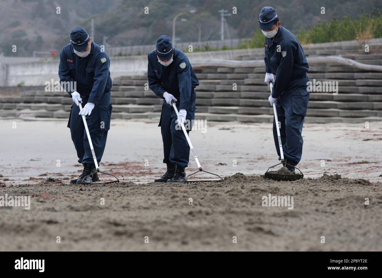 Fukushima Prefectural police officers search for four missing people at ...