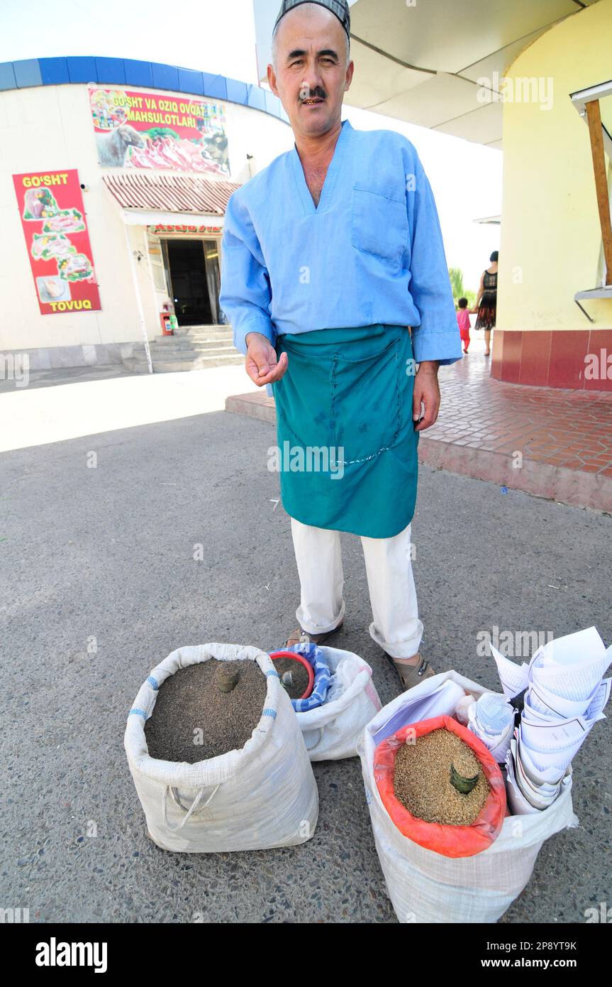 An Uzbek man selling spices at the Charsu bazaar in Tashkent ...