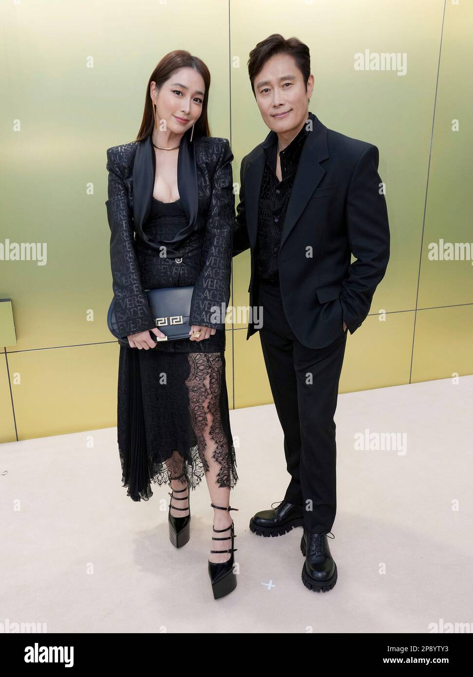 Lee Min-jung, left, and Lee Byung-hun arrive at the Versace Fall/Winter ...
