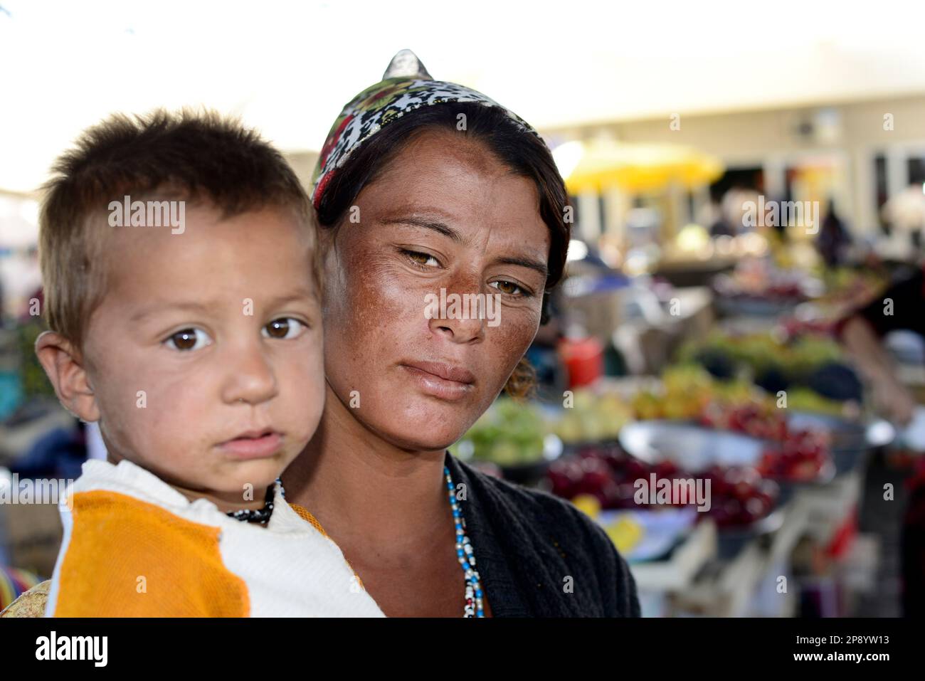 A Gypsy woman with her son visiting the market in Bukhara, Uzbekistan ...