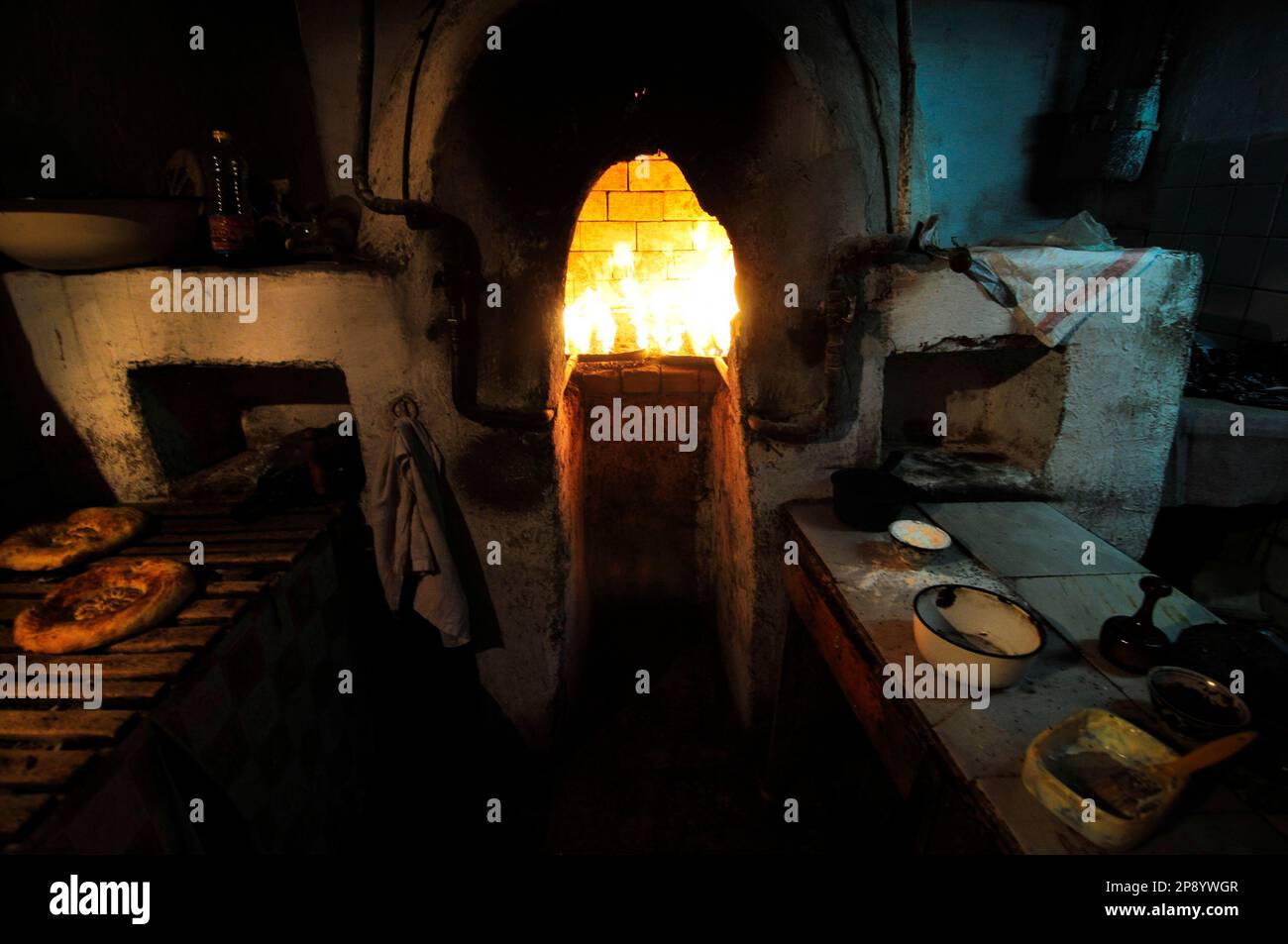 Obi-non bread being baked in a small bakery in the old city of Bukhara ...