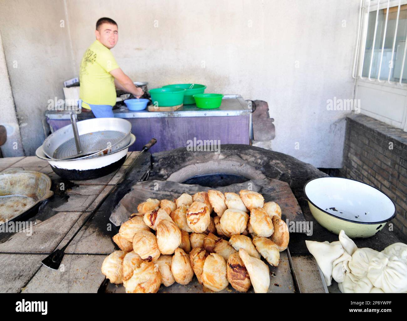 Uzbek Samsa ( flaky baked meat buns ) baked in a tandoor oven is a ...