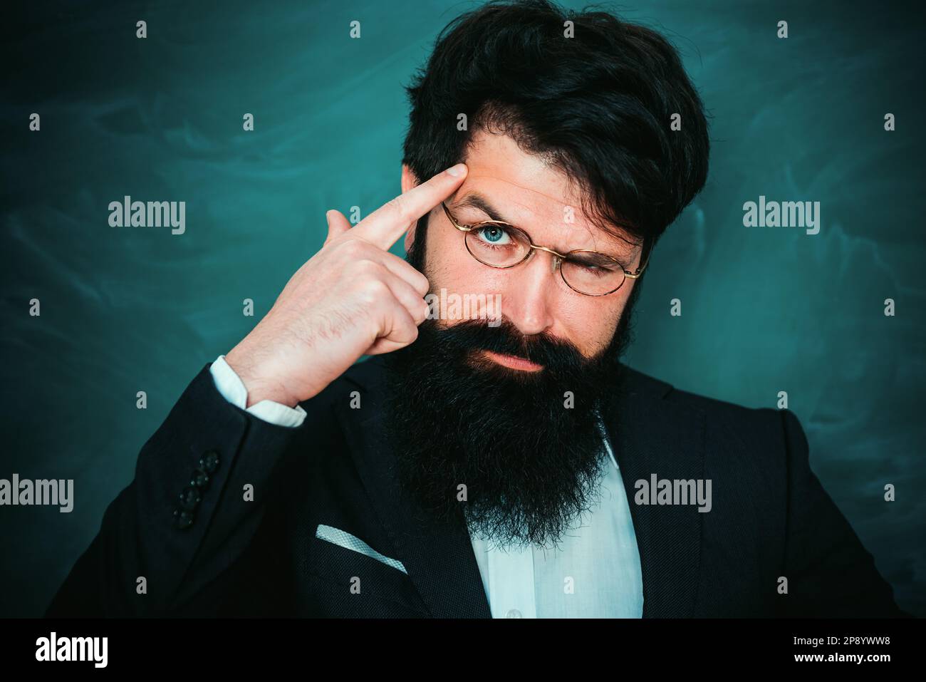 Professor in class on blackboard background. Young teacher near ...