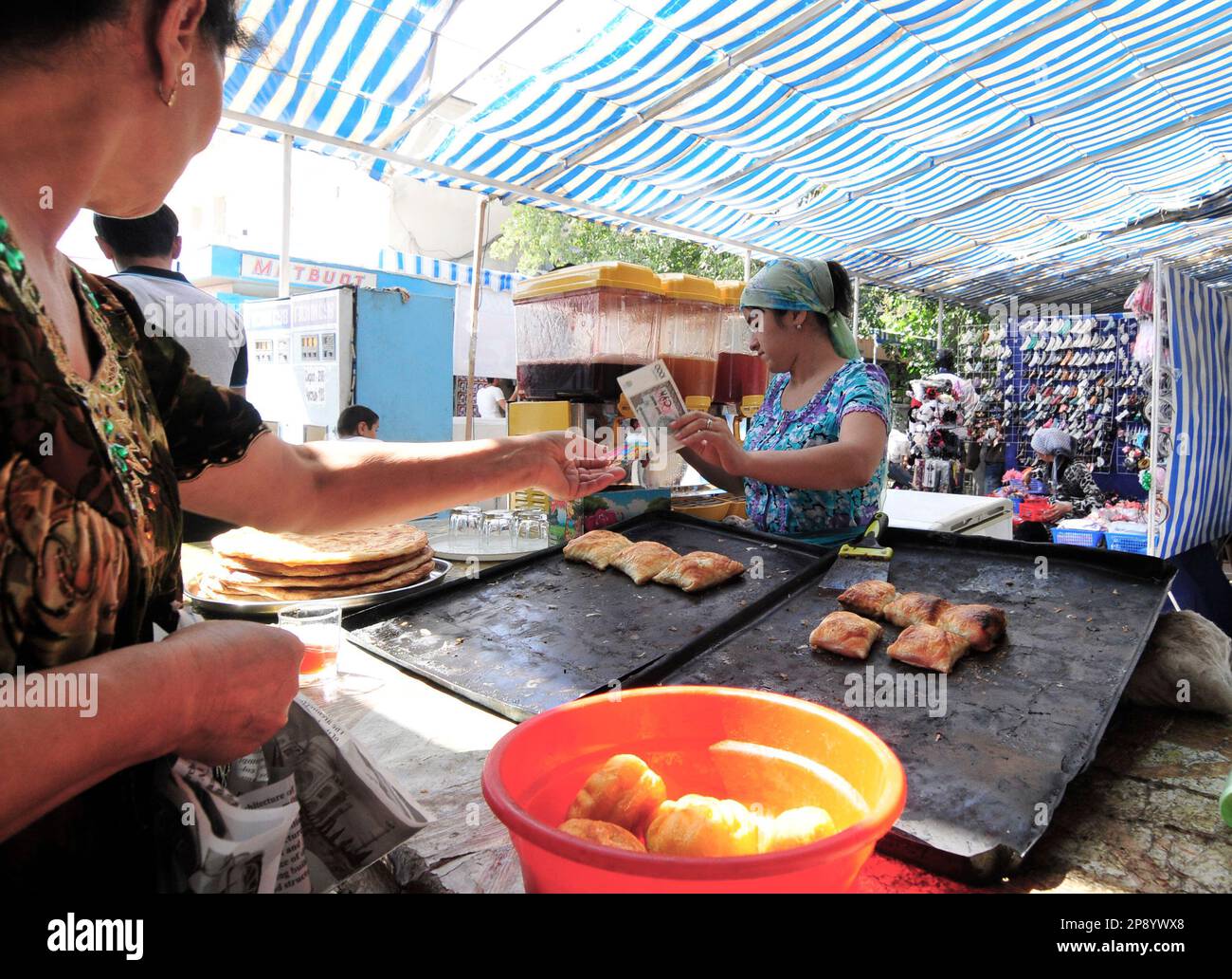 Uzbek Samsa ( flaky baked meat buns ) vendor at the market in Bukhara ...