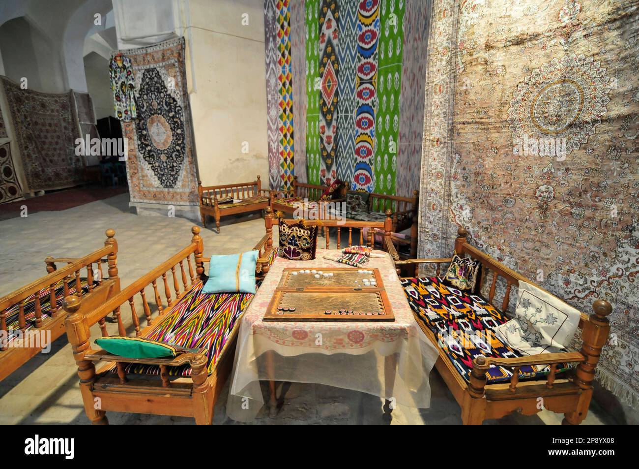 Young Uzbek kids playing backgammon at the old carpet bazaar in the old ...
