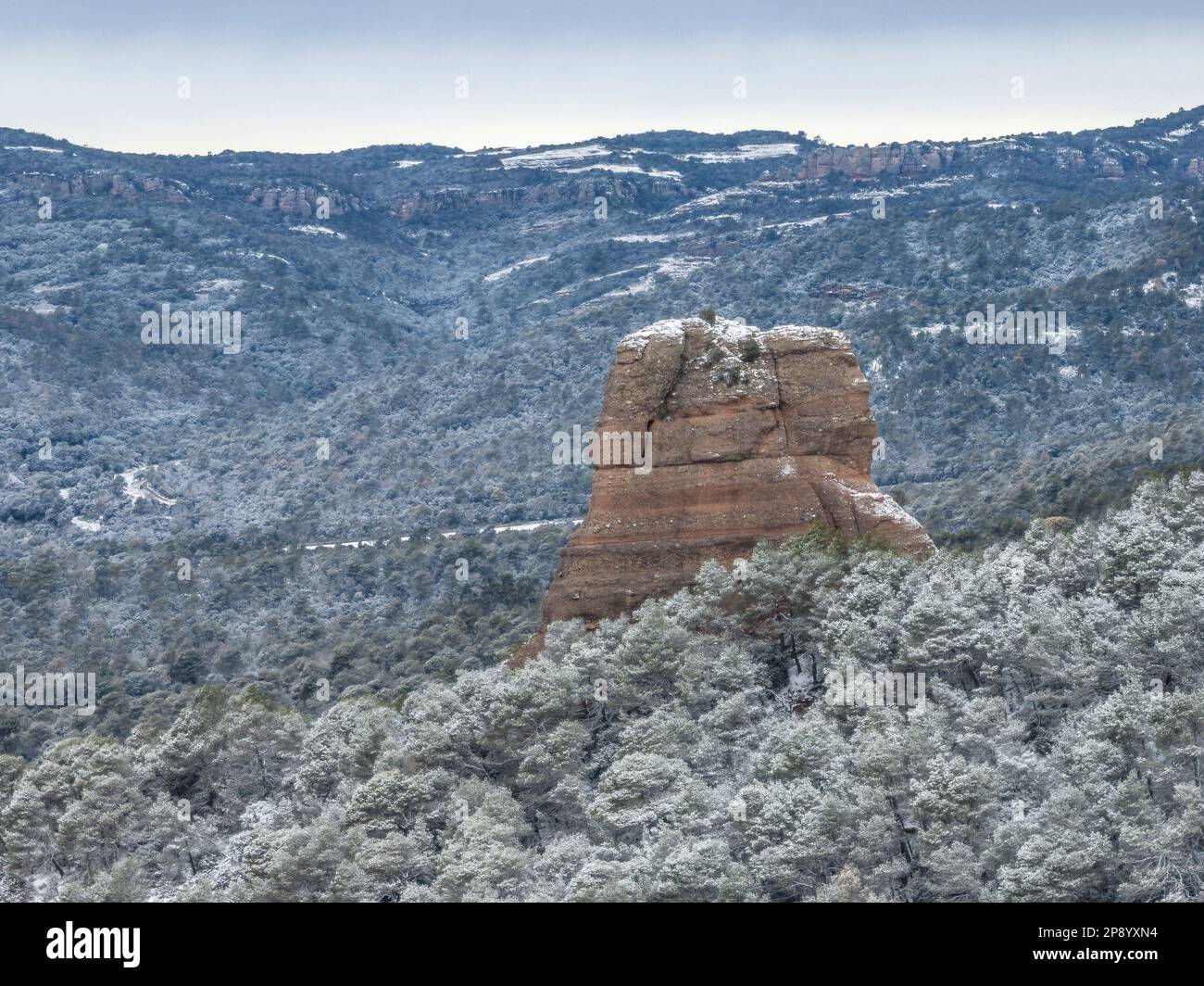 Aerial view of the snowy Cavall Bernat of Matadepera rock, in La Mola ...
