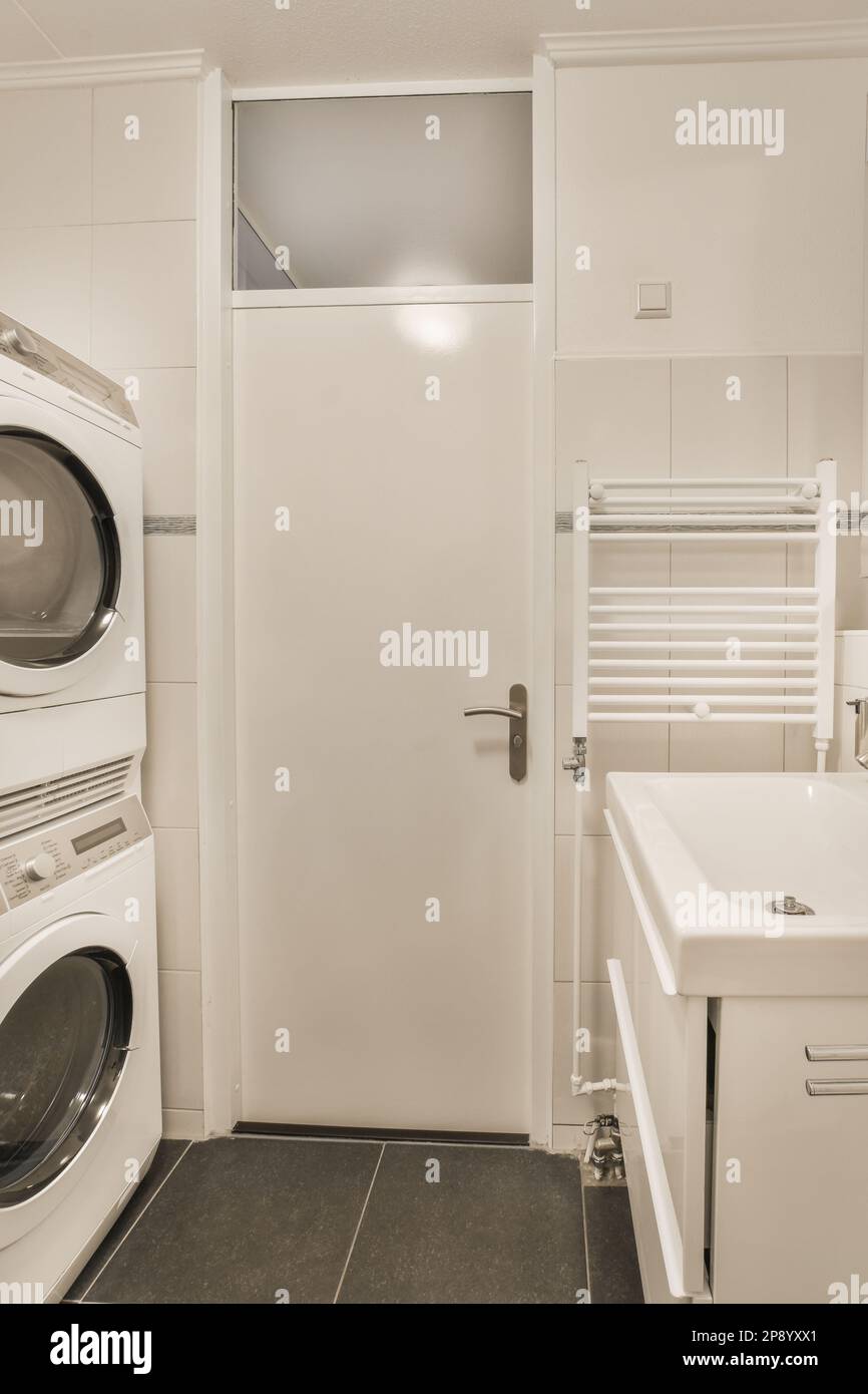 a laundry room with a washer and dryer in front of the washing machine ...