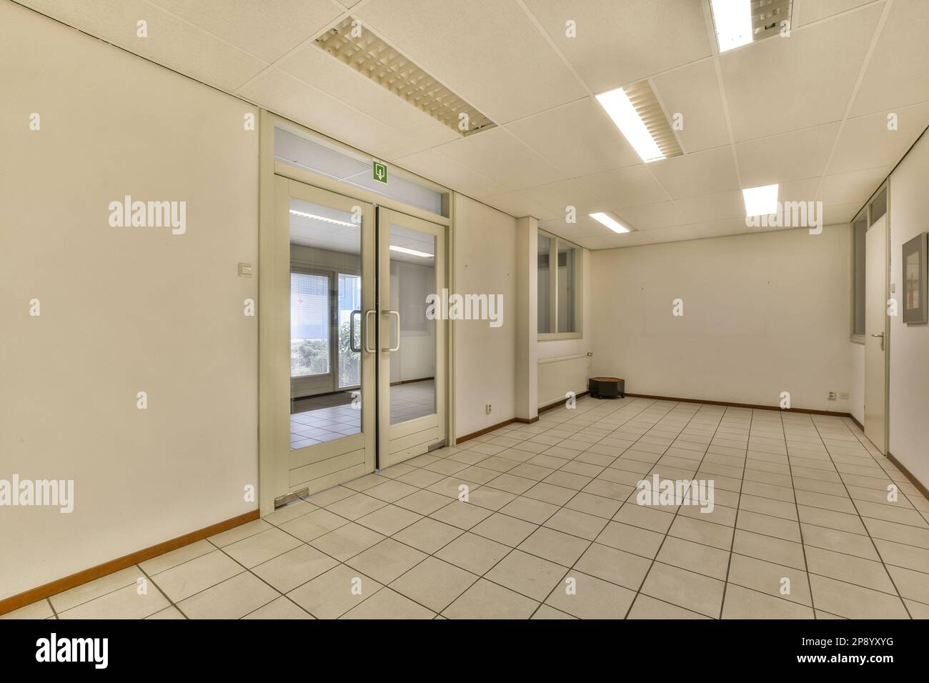an empty room with white walls and tile flooring, there is no one ...