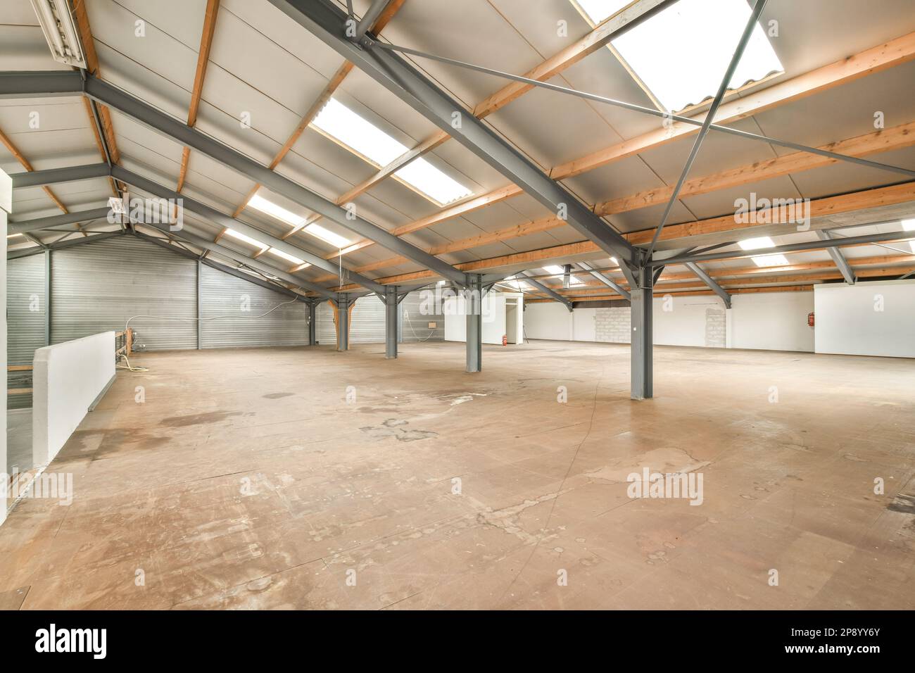 the inside of an empty building with exposed ceilings and wood beams on ...