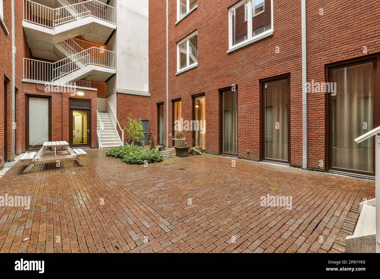 a brick courtyard with stairs and balks on the left side of the ...