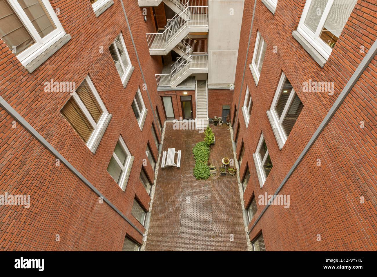 an apartment building with brick walls and stairs leading up to the ...