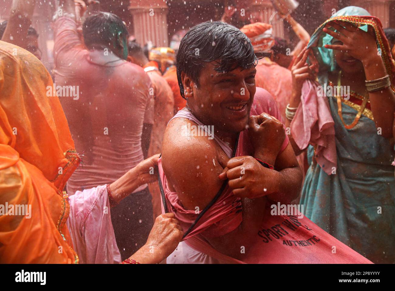 Mathura, India. 09th Mar, 2023. A woman tears the shirt off a man during the "Huranga", a game ...