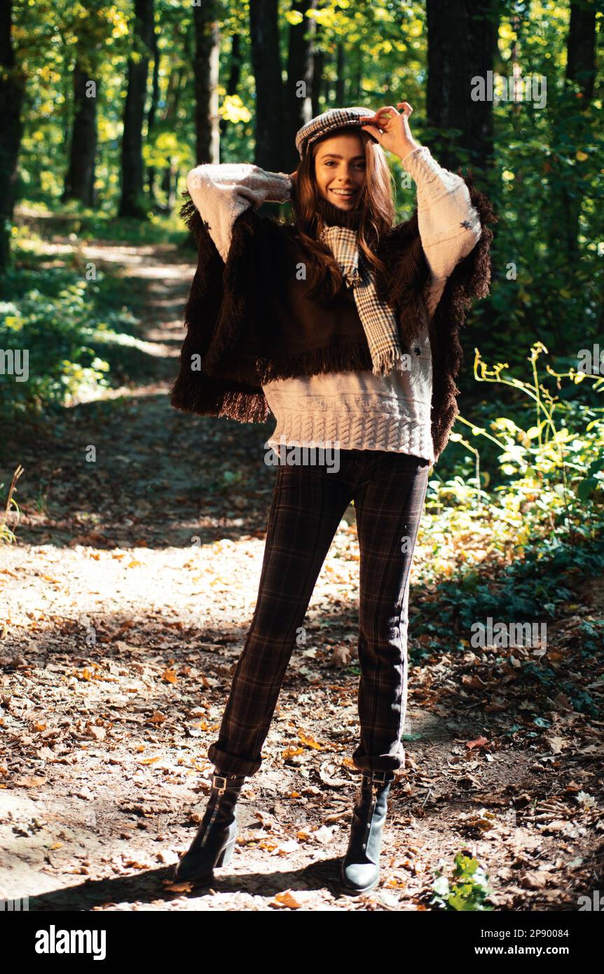 Cute girl in good mood posing in autumn day. Dreamy girl with long hair ...
