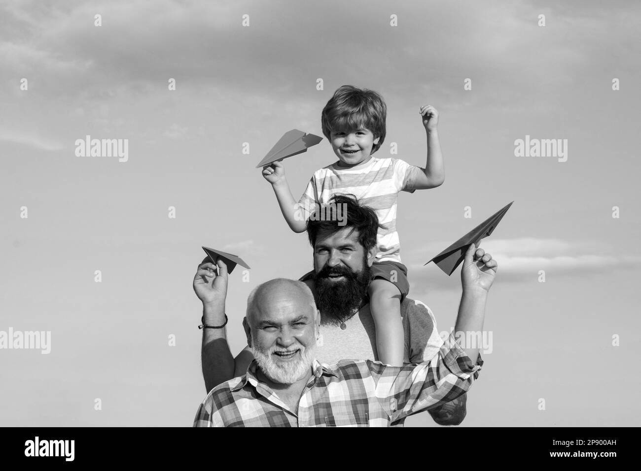 Happy smiling boy on shoulder dad looking at camera. Male multi ...
