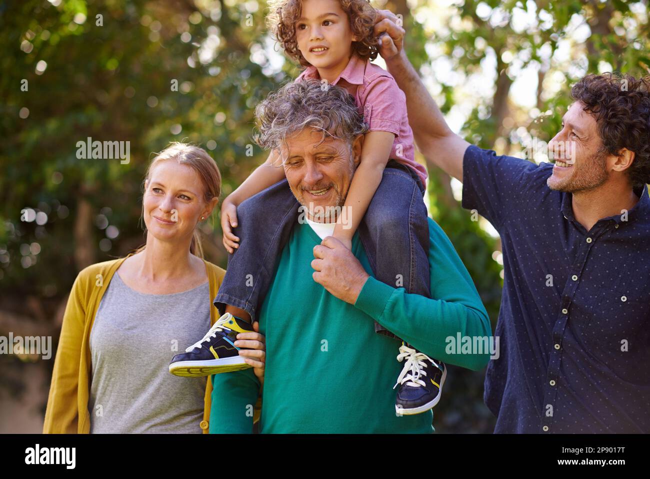 Stay connected to family. a multi-generational family standing together ...