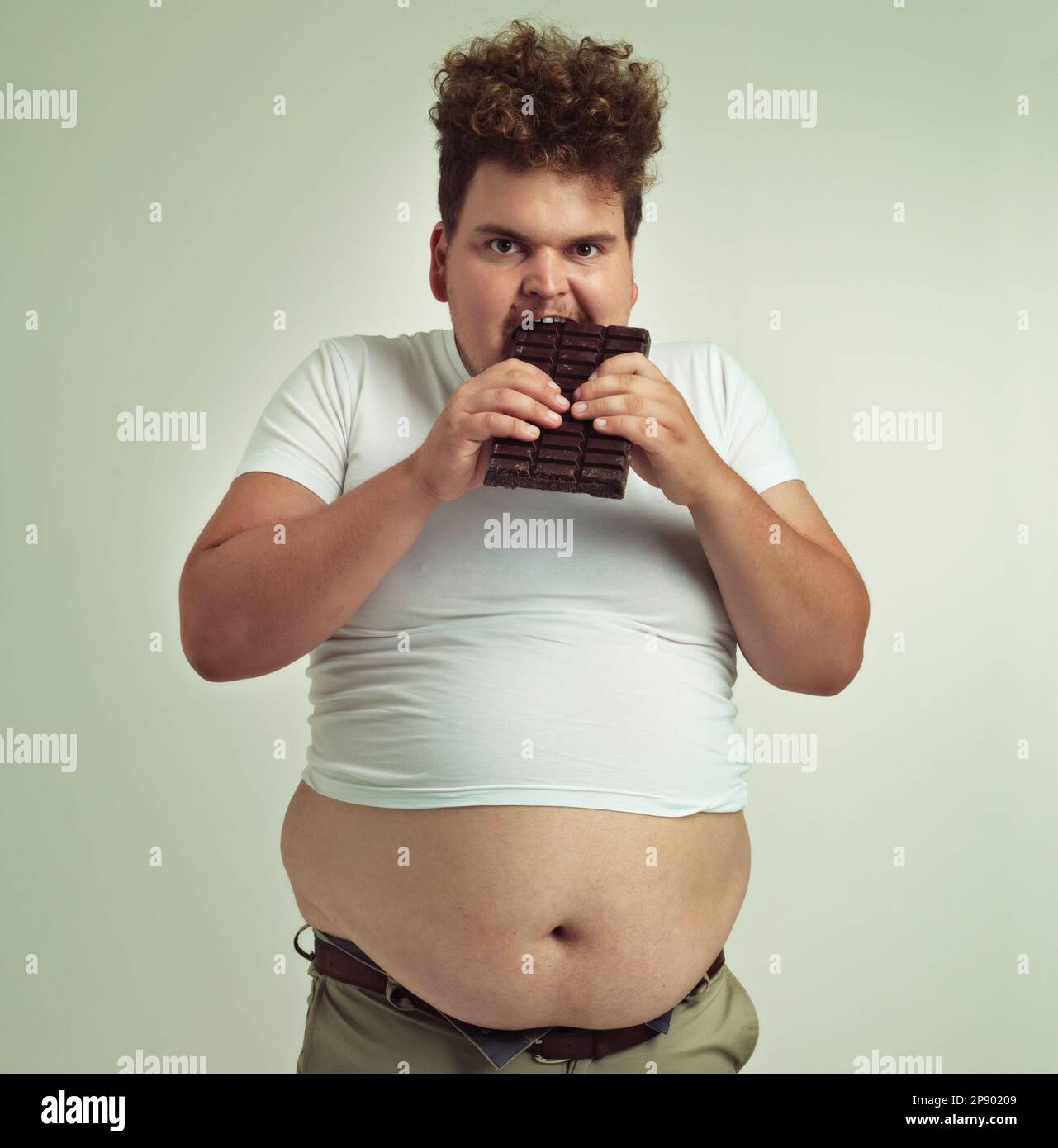 Om nom nom nom nom. an overweight man biting into a large block of ...