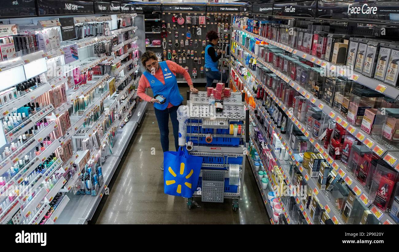 An employee organizes beauty products inside the Walmart Supercenter in ...