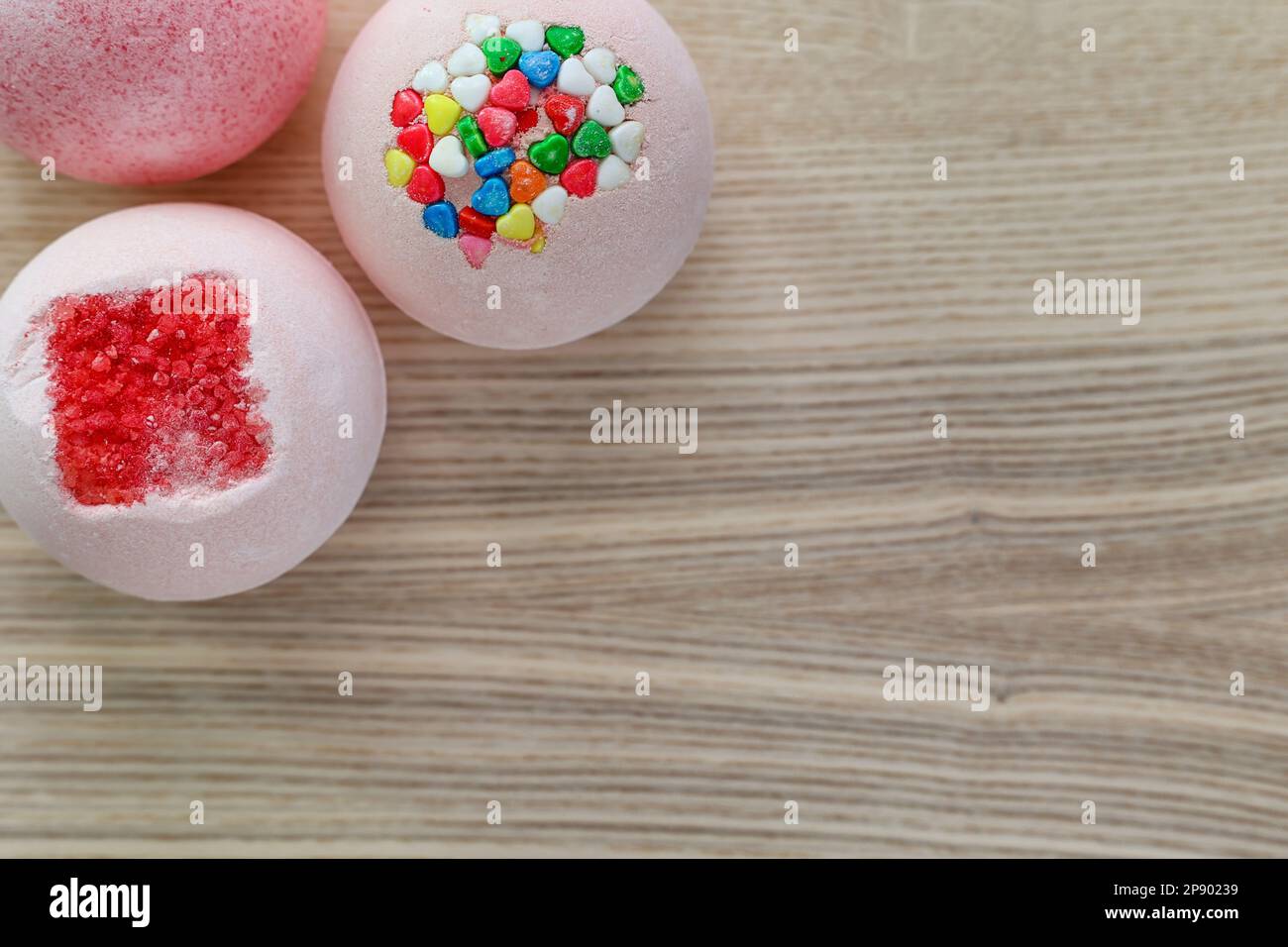 Different bath bombs on light wooden table, top view Stock Photo - Alamy