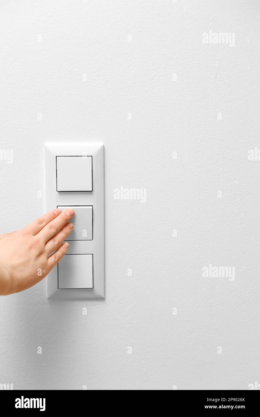 Woman switching on light hi-res stock photography and images - Alamy
