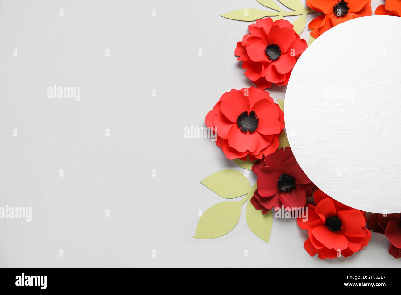 Blank paper sheet with poppy flowers and leaves on grey background ...