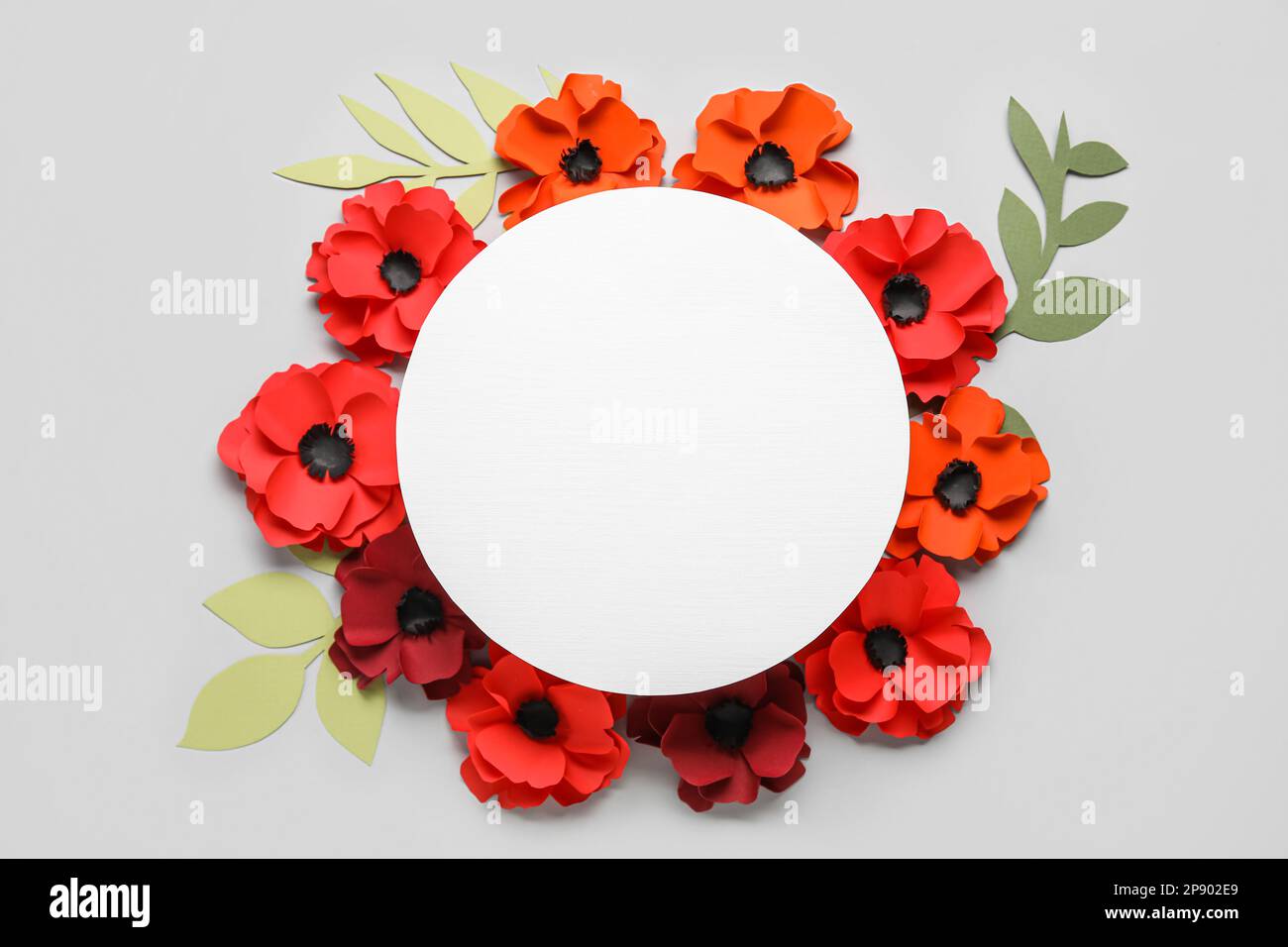 Blank paper sheet with poppy flowers and leaves on grey background ...