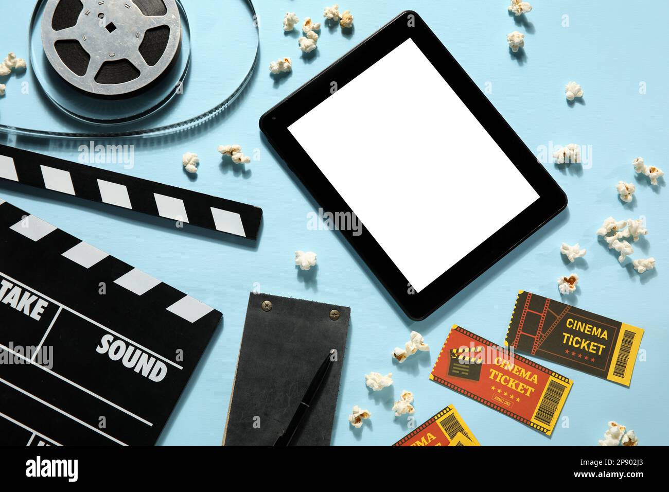 Movie clapper with reel, popcorn, tablet computer, tickets and popcorn ...