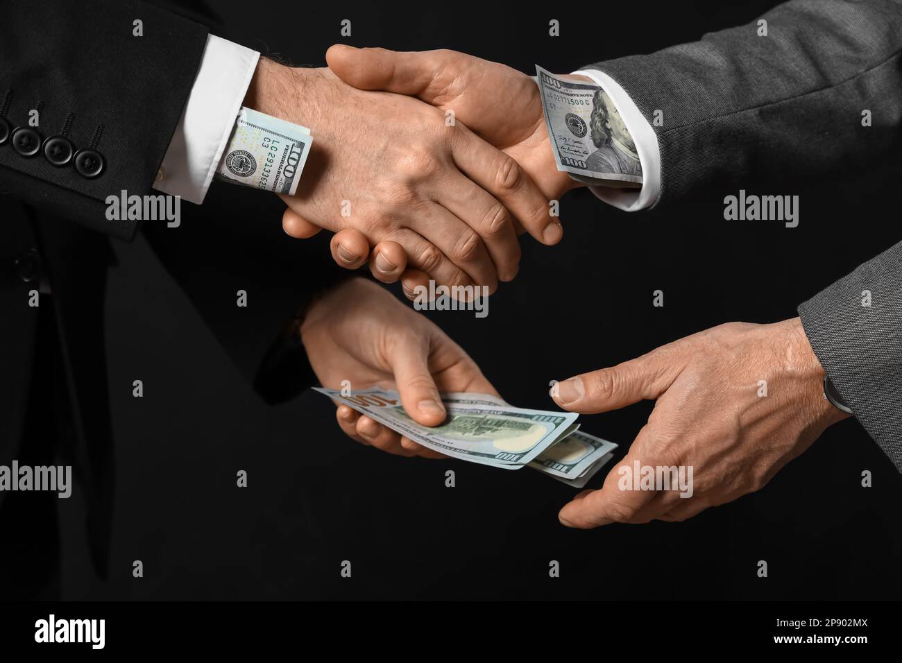 Men with bribe shaking hands on dark background, closeup Stock Photo ...