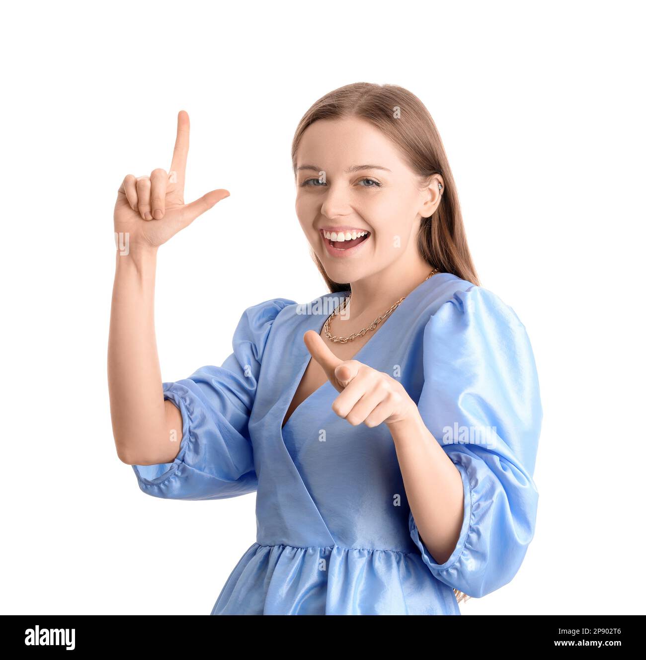 Young woman in dress showing loser gesture and pointing at viewer on ...