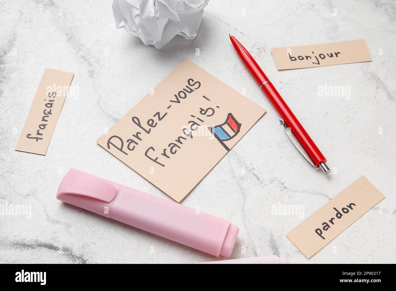 Papers with French words, pens and crumpled paper on grunge background ...