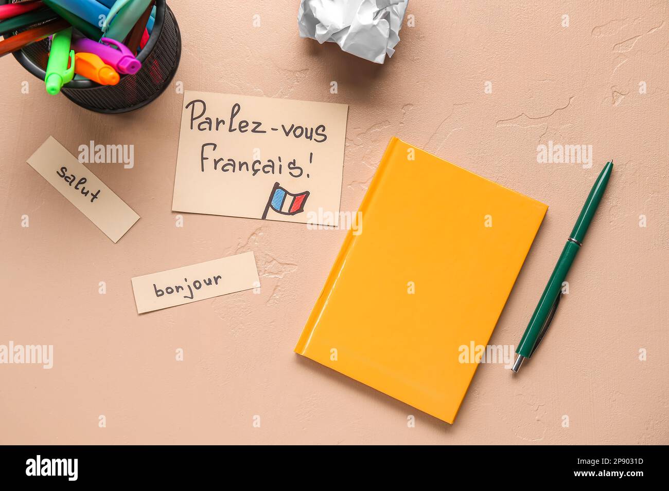 Papers with French words and stationery on beige background Stock Photo ...