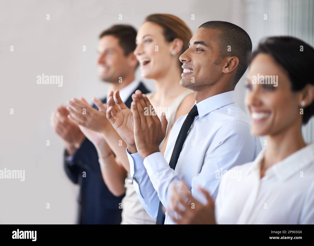 An enthusiastic round of applause. a row of businesspeople clapping ...