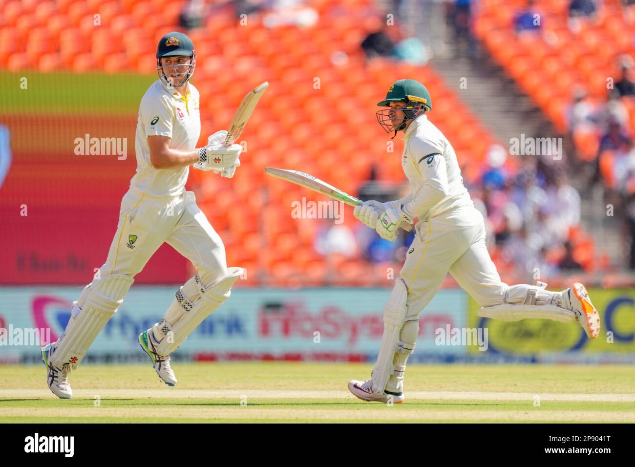 Australia's Cameron Green, left, and Usman Khawaja run between the ...