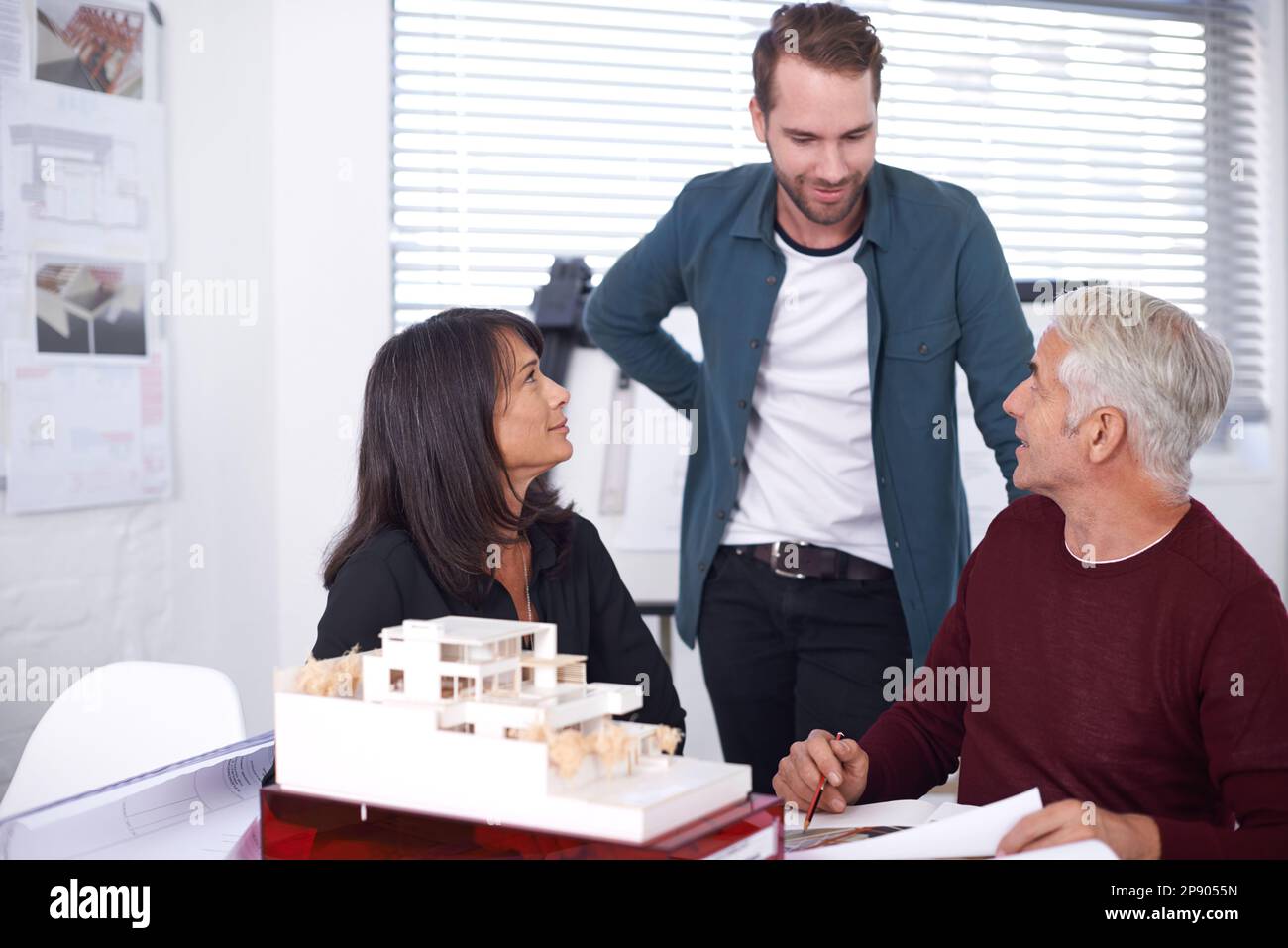 Every detail is equally important. three architects working on a new ...