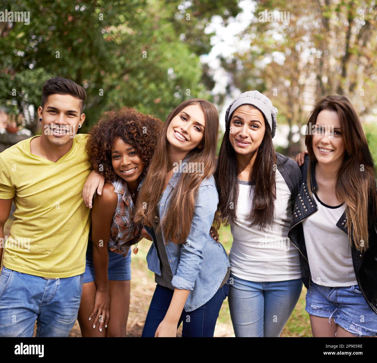 Hanging out with the gang. Portrait of a group of young friends hanging ...