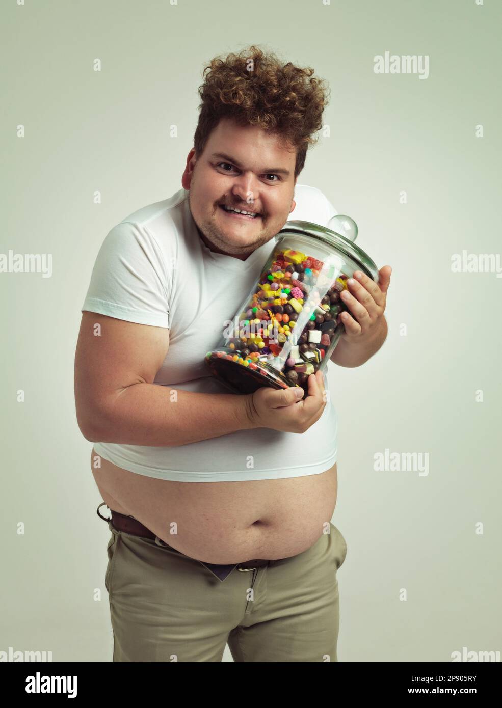 I love candy, can you tell. an overweight man holding a pot of candy ...