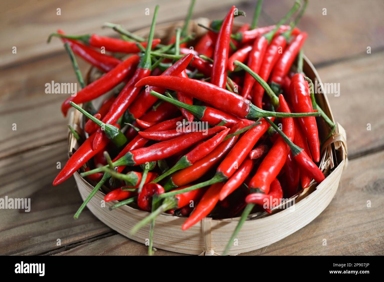 Chili pepper, Red hot chilli peppers on basket background. Close up ...