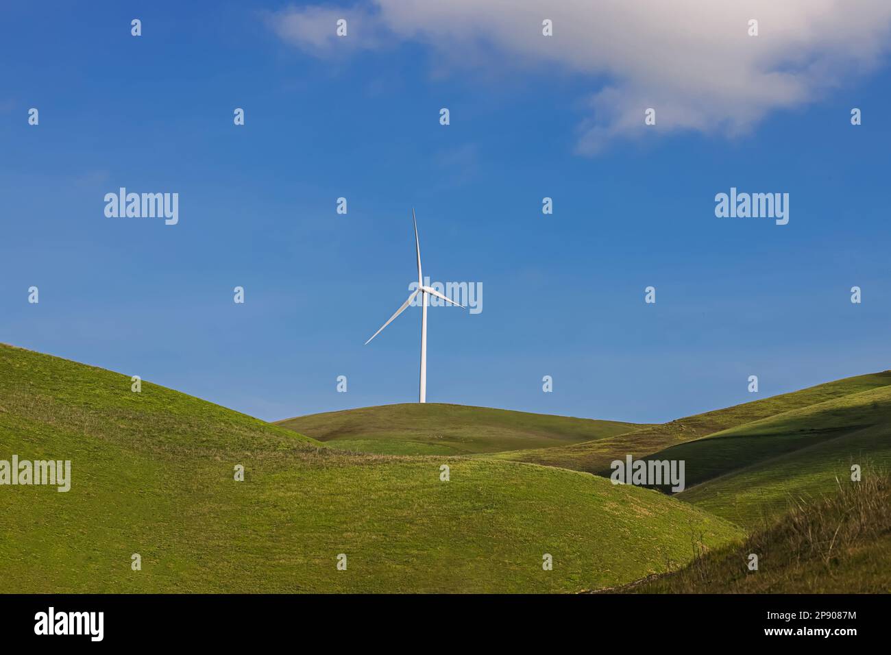 Wind power mill on the green hills, clean energy Stock Photo - Alamy