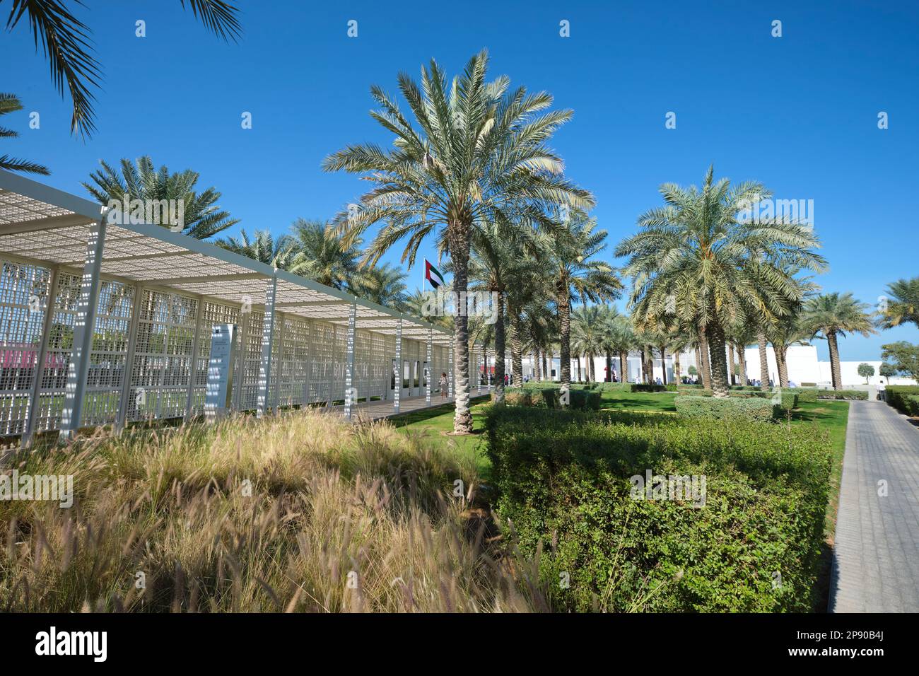 Palm trees, flag and the white grid walkway, path covering from the ...