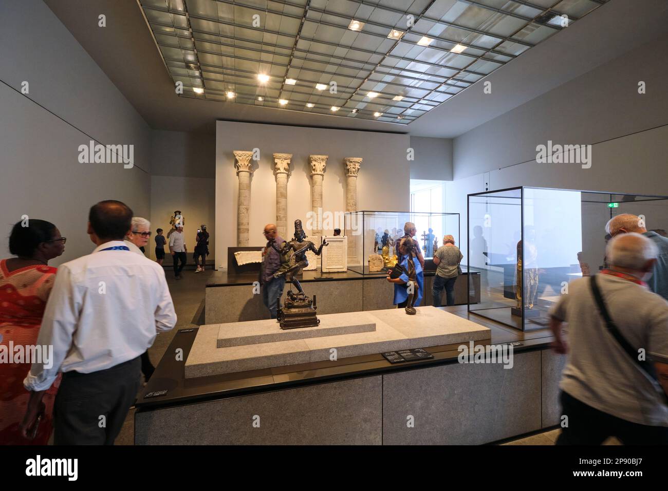 A bronze Indian sculpture and a set of ancient columns in an artifacts gallery, room. At the ...